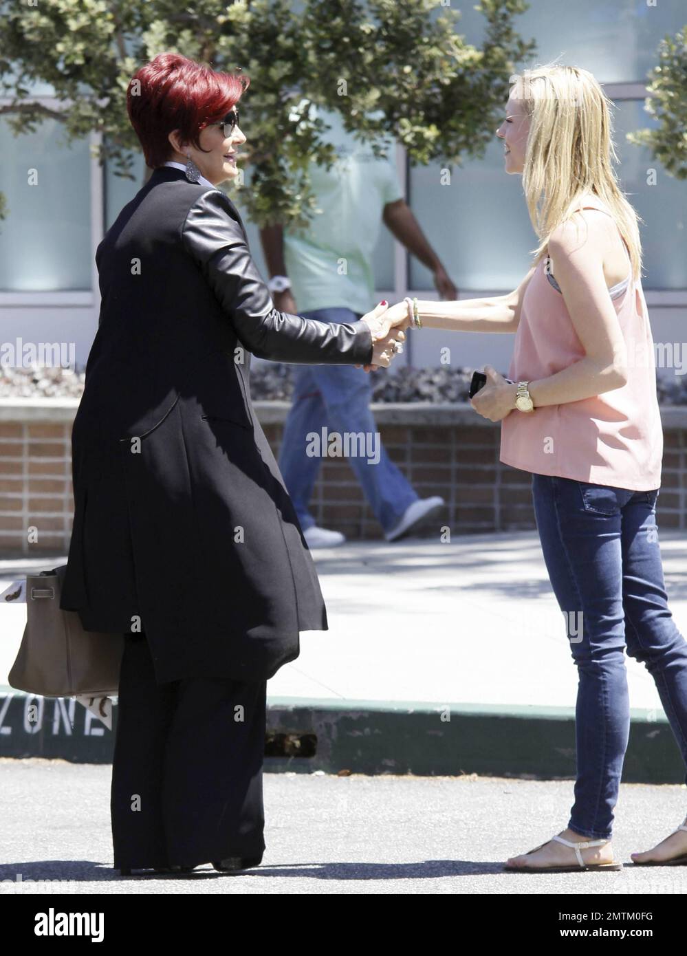 EXCLUSIVE!! Sporting bright-red hair and a long black suit, "America's ...