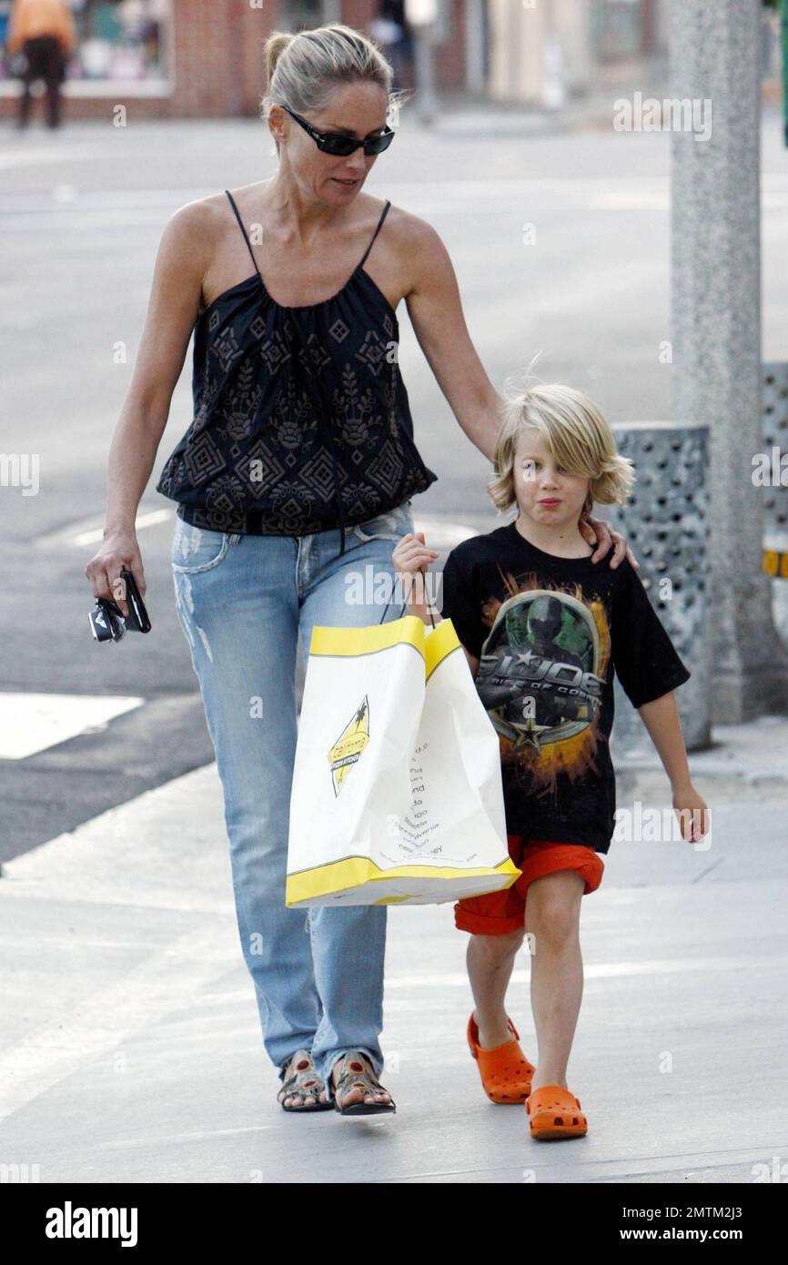 Actress Sharon Stone wears a geometrically patterned top and jeans as ...