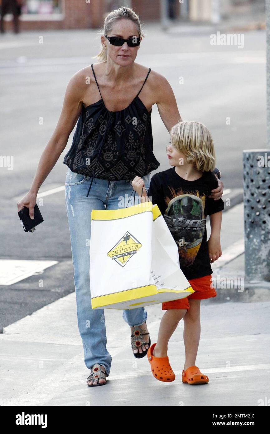 Actress Sharon Stone wears a geometrically patterned top and jeans as ...