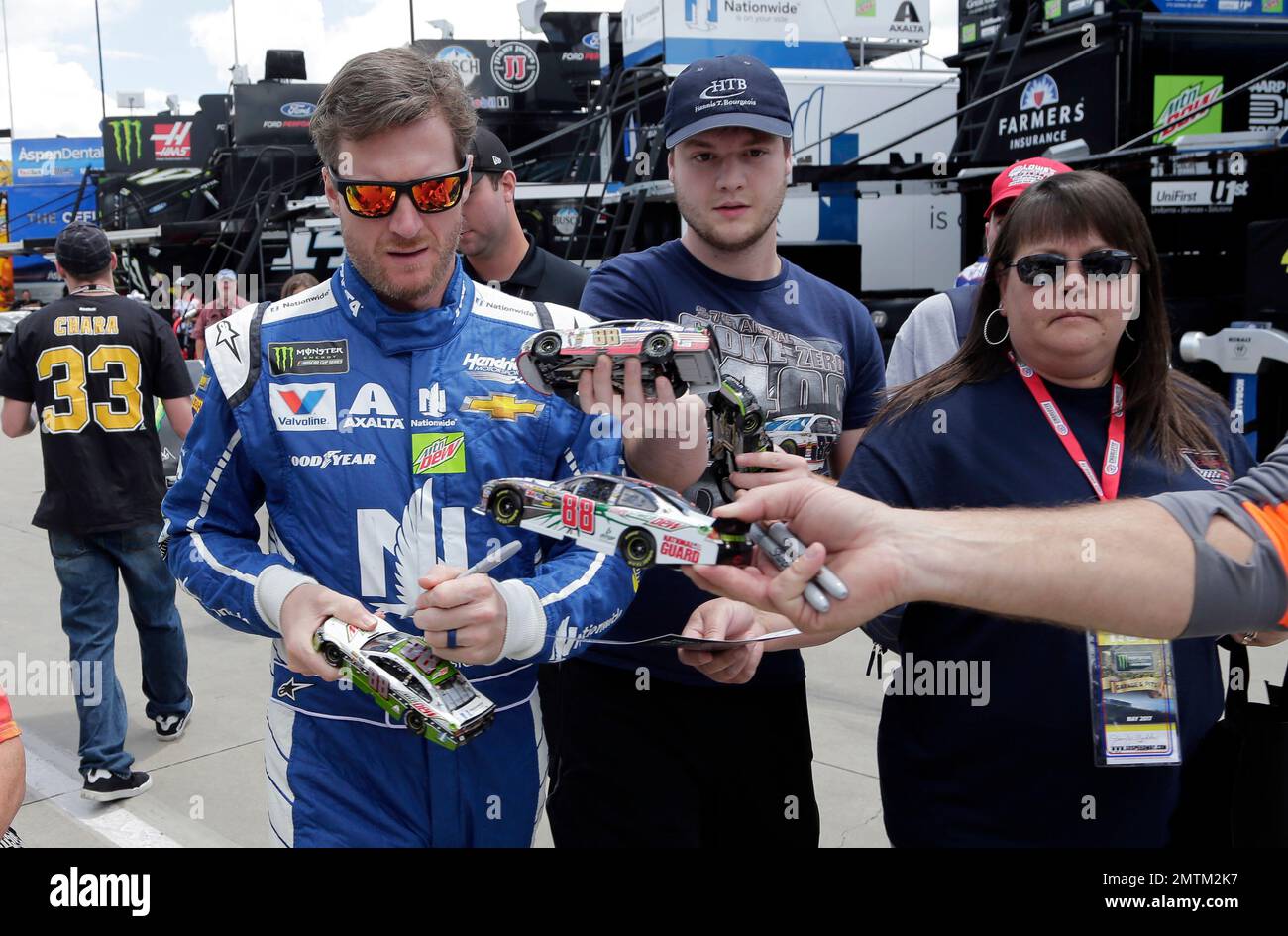 Dale Earnhardt Jr. signs autographs before practice for Sunday's NASCAR ...