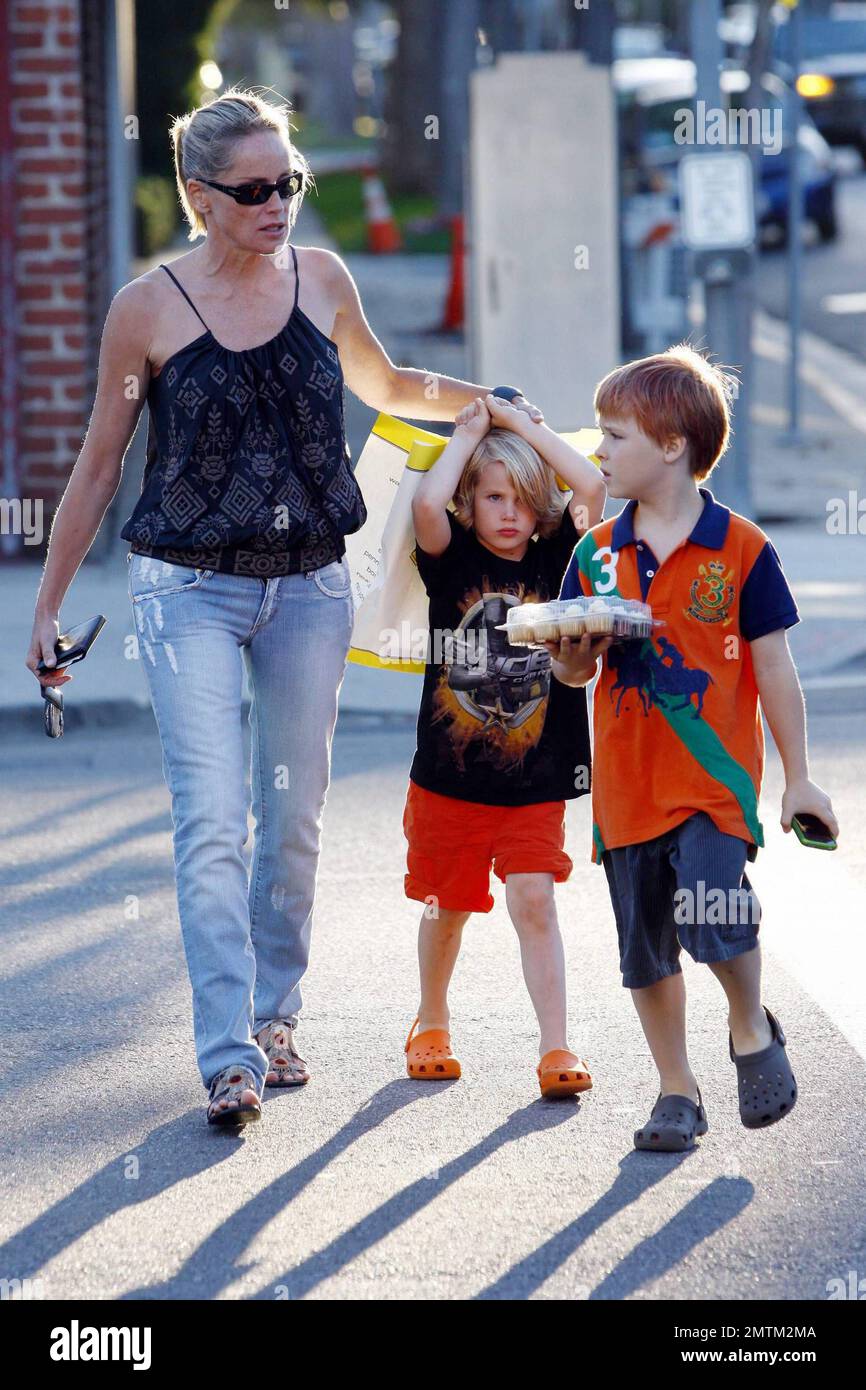 Actress Sharon Stone wears a geometrically patterned top and jeans as ...