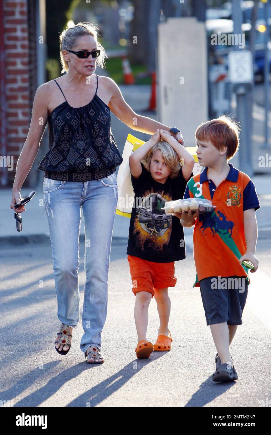 Actress Sharon Stone wears a geometrically patterned top and jeans as ...