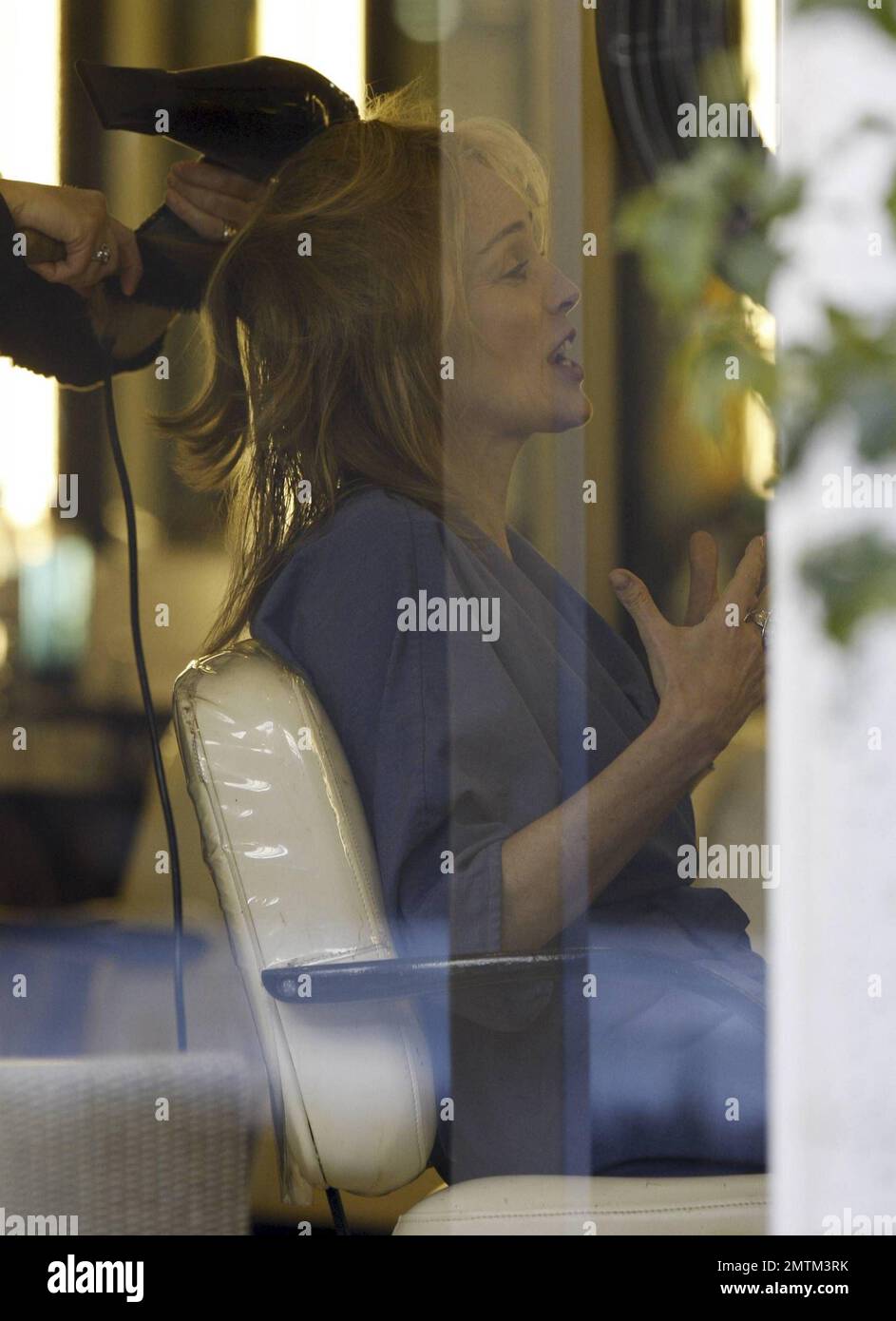 Sharon Stone shares a laugh with her stylist while getting her hair ...