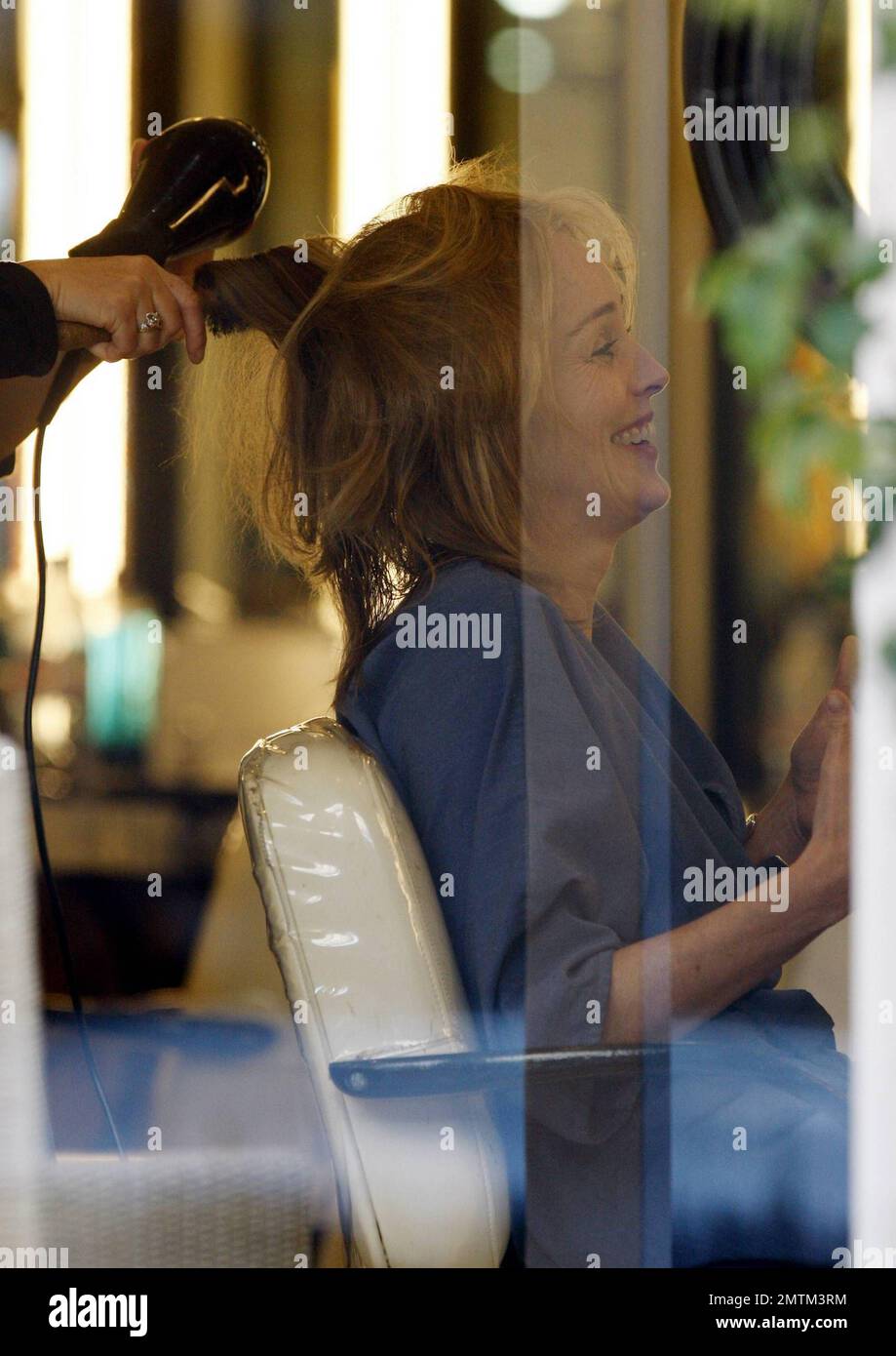 Sharon Stone shares a laugh with her stylist while getting her hair ...