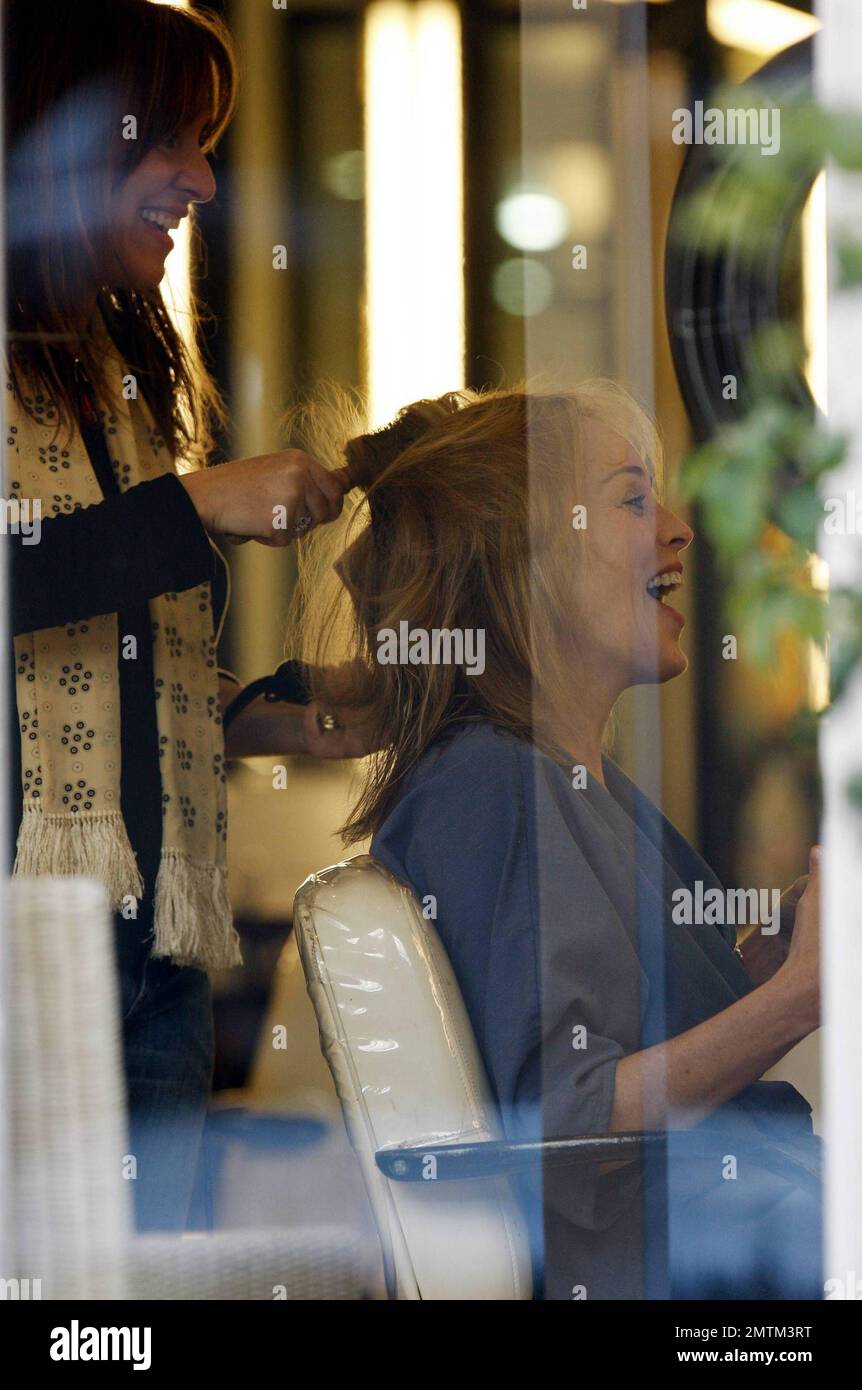 Sharon Stone shares a laugh with her stylist while getting her hair ...