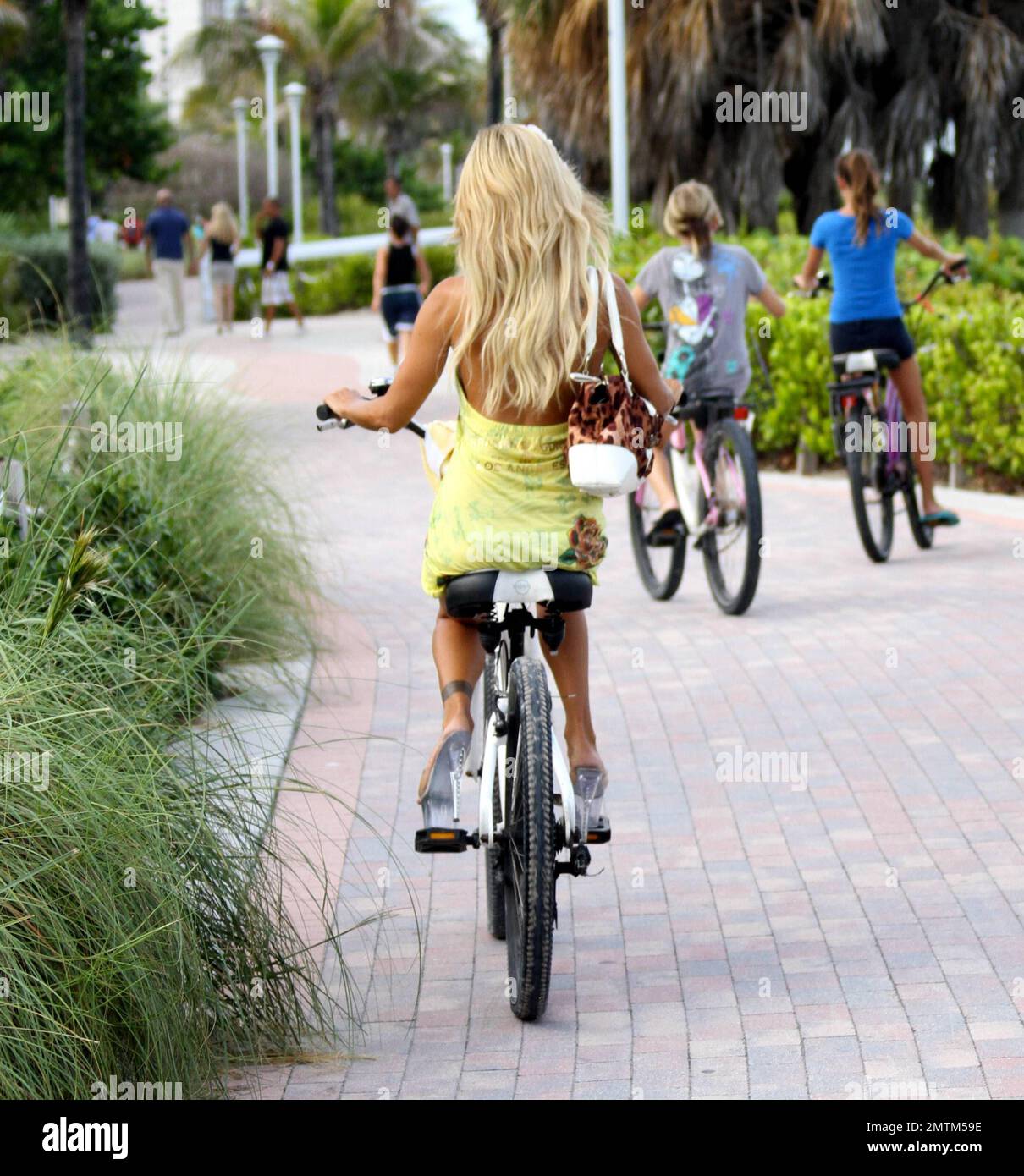 Shauna Sand takes the kids for a bike ride along the beach at sunset ...