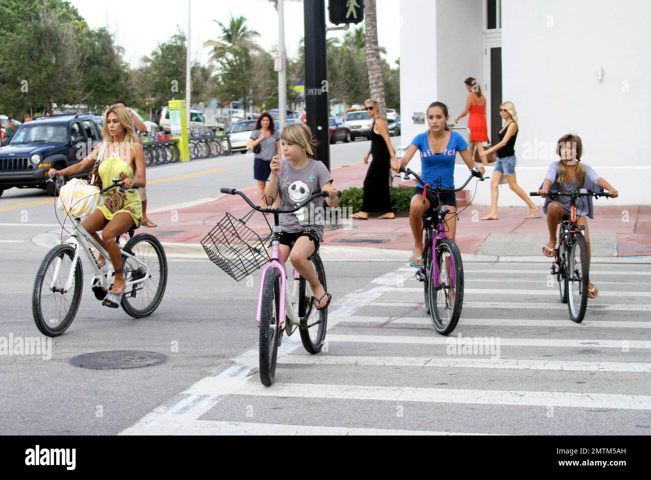 Shauna Sand takes the kids for a bike ride along the beach at sunset ...