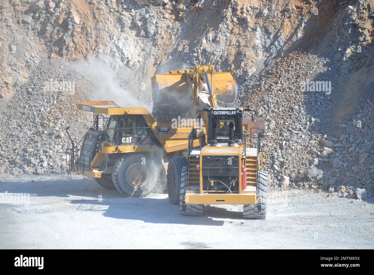 Wheel loader loading limestone to the dumper. Working at a limestone ...