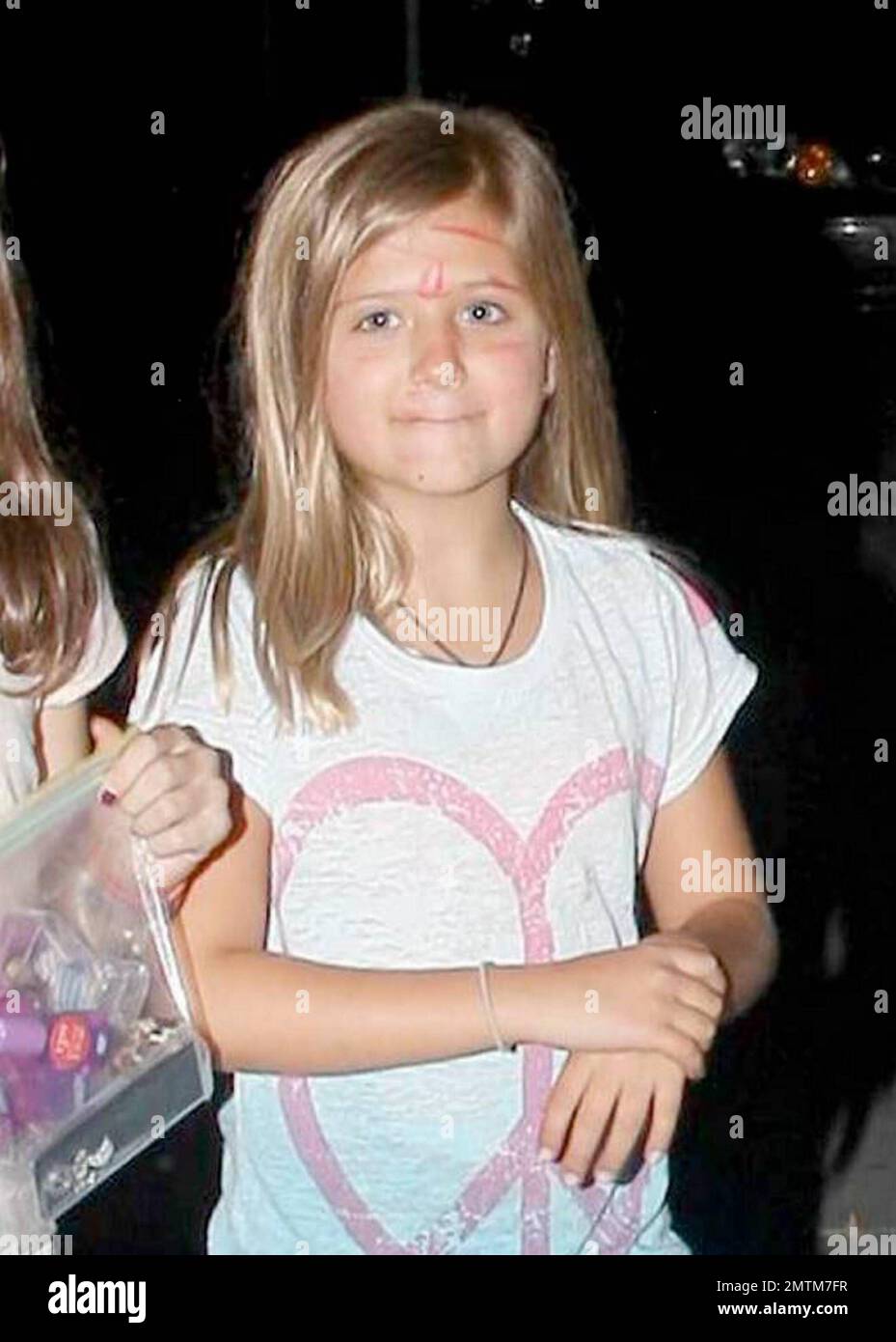 Shauna Sand is dressed down in a torn t shirt and jeans as she spends a ...