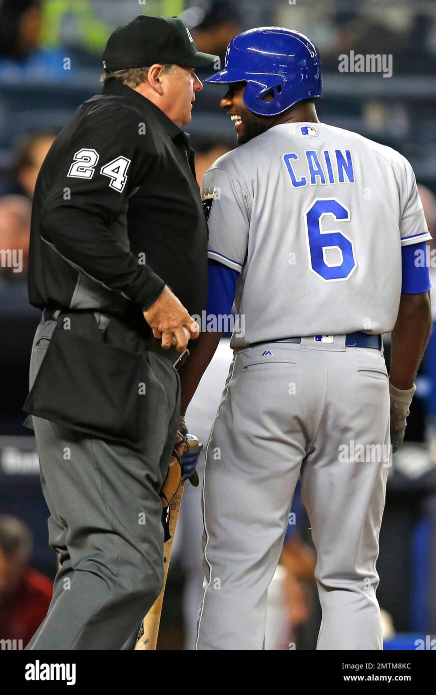 Home plate umpire Jerry Layne (24) shares a laugh with Kansas City ...