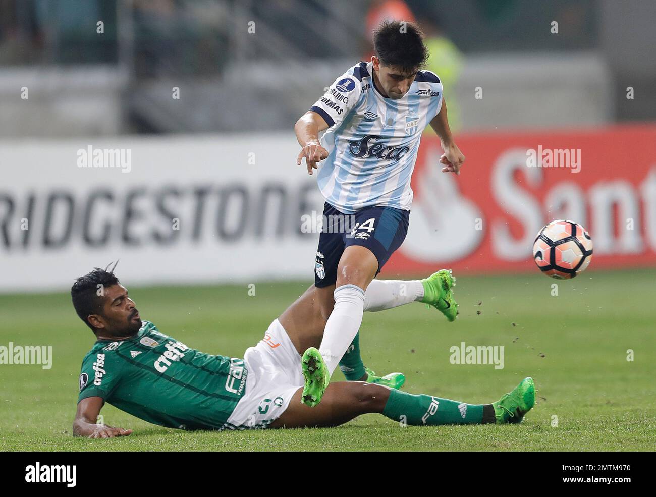 Ignacio Canuto of Argentina's Atletico Tucuman, right, fights for the ...