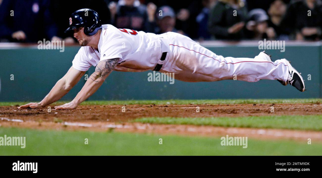 Boston Red Sox's Sam Travis dives for home as he scores on a pinch-hit ...