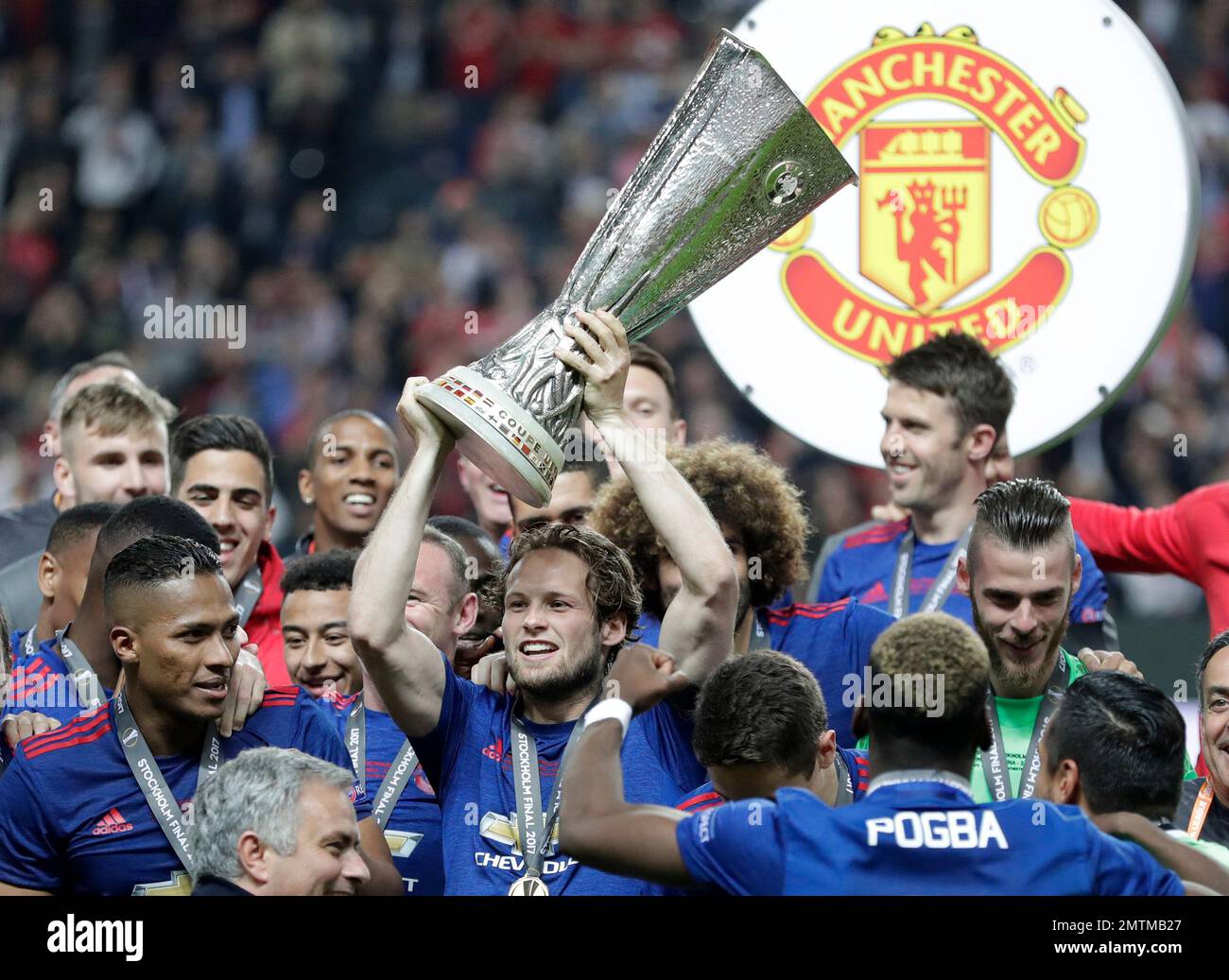Manchester's Daley Blind holds the trophy after winning 2-0 during the ...