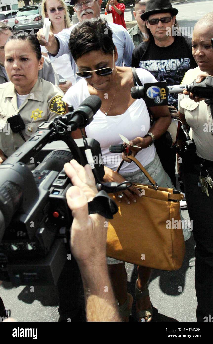 Lindsay Lohan's attorney Shawn Chapman Holly carries along a coffee as ...