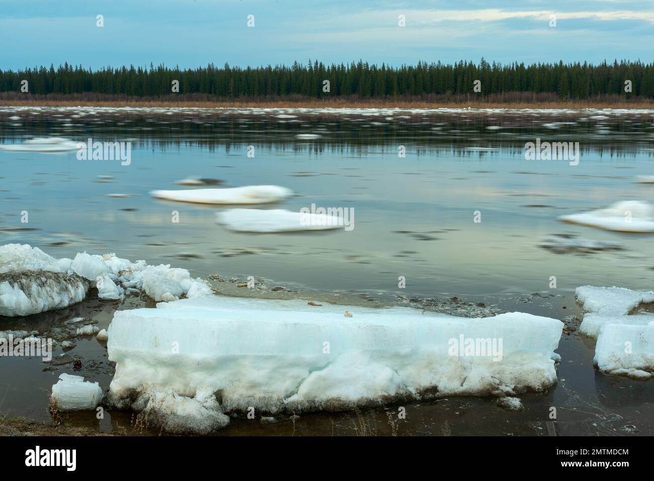 Ice floes lie on the banks of the Vilyui River in Yakutia against the ...