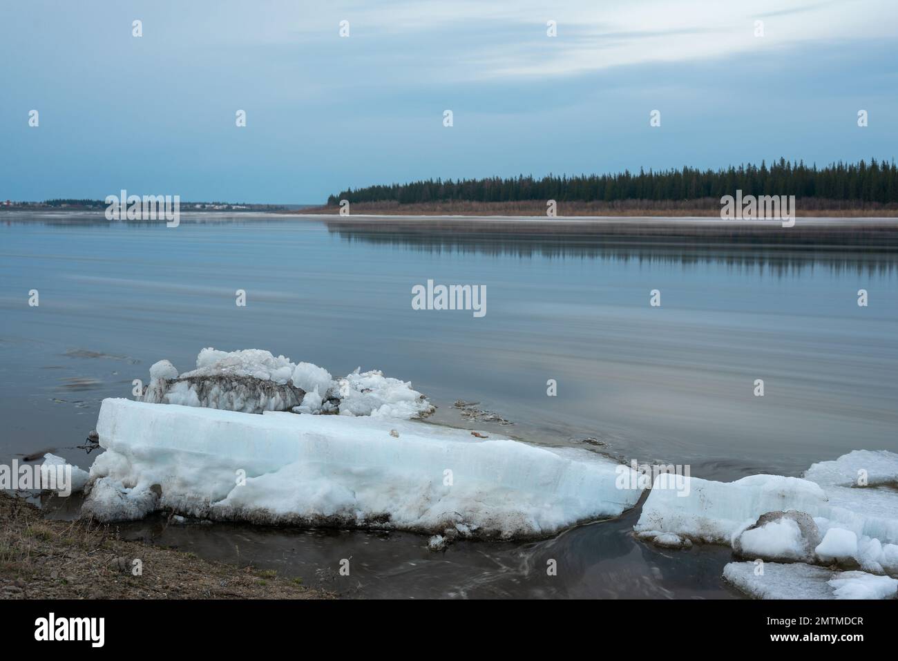 Ice floes lie on the banks of the Vilyui River in Yakutia against the ...