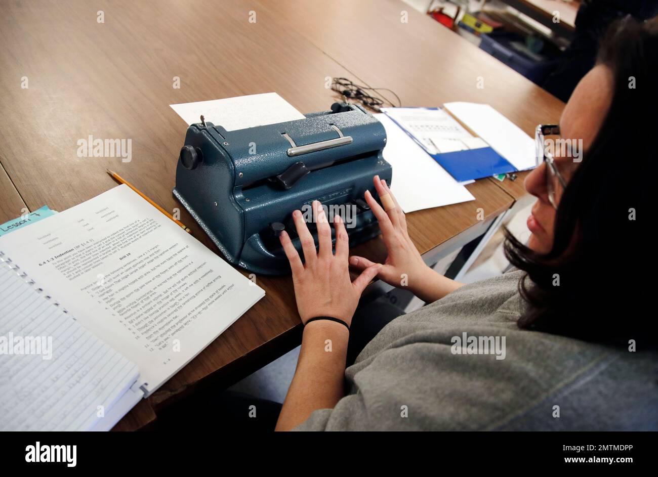 In this May 22, 2017 photo, inmate Nicole Belonga types on a Perkins ...