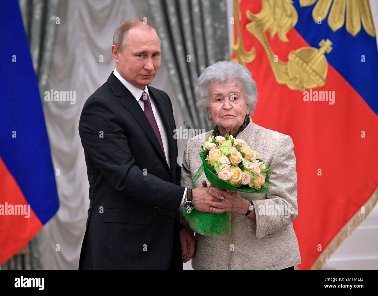 Russian President Vladimir Putin presents a medal to the Pushkin fine ...
