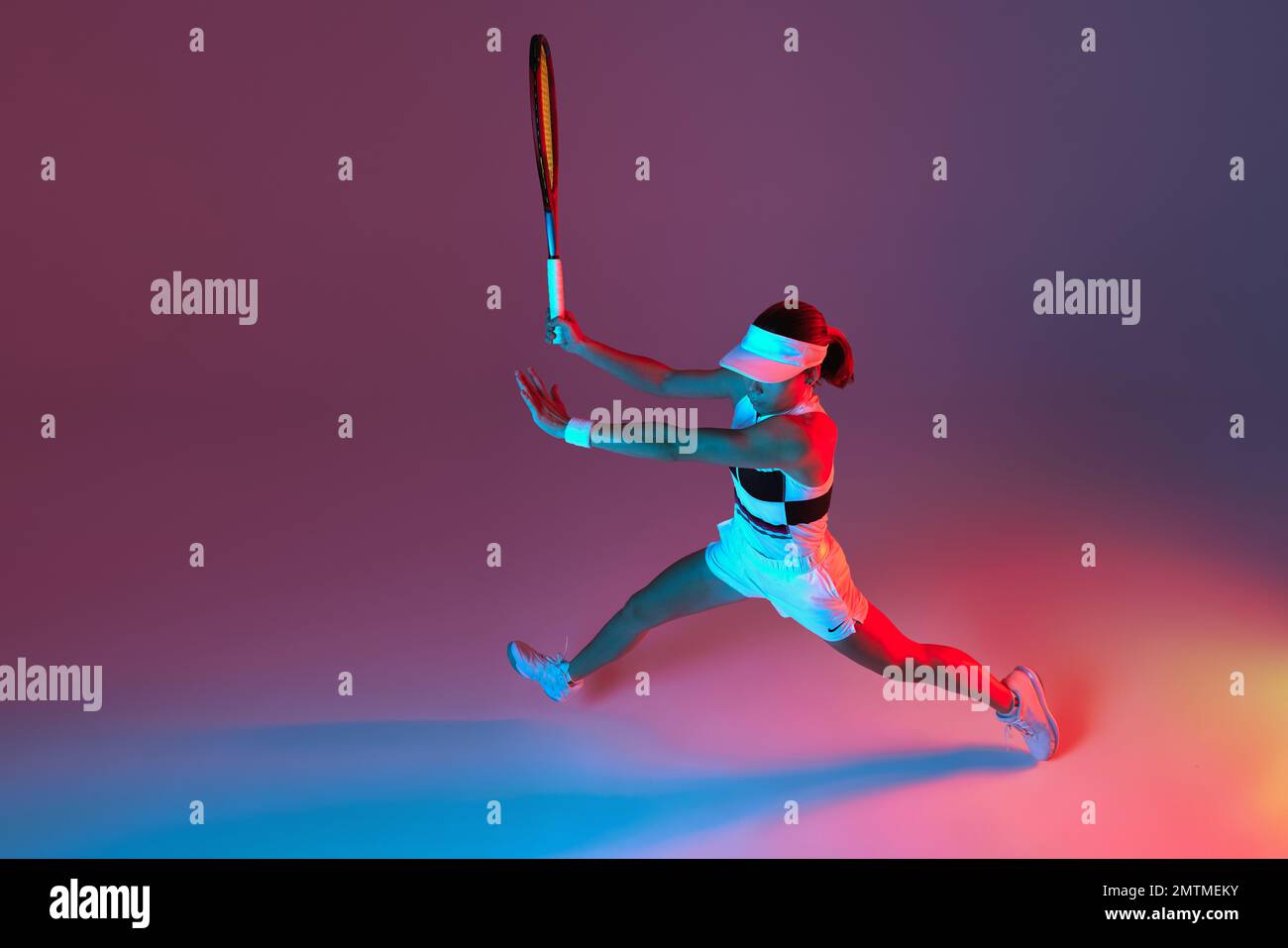 Studio shot of active professional tennis player training with tennis ...