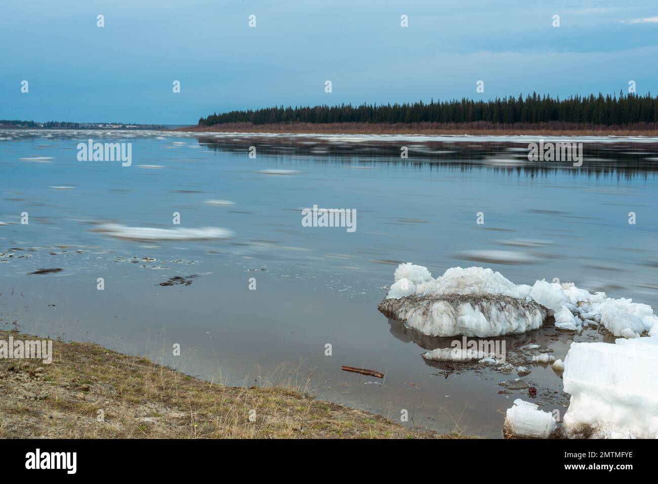 The remains of the last spring ice on the river in Yakutia float near ...