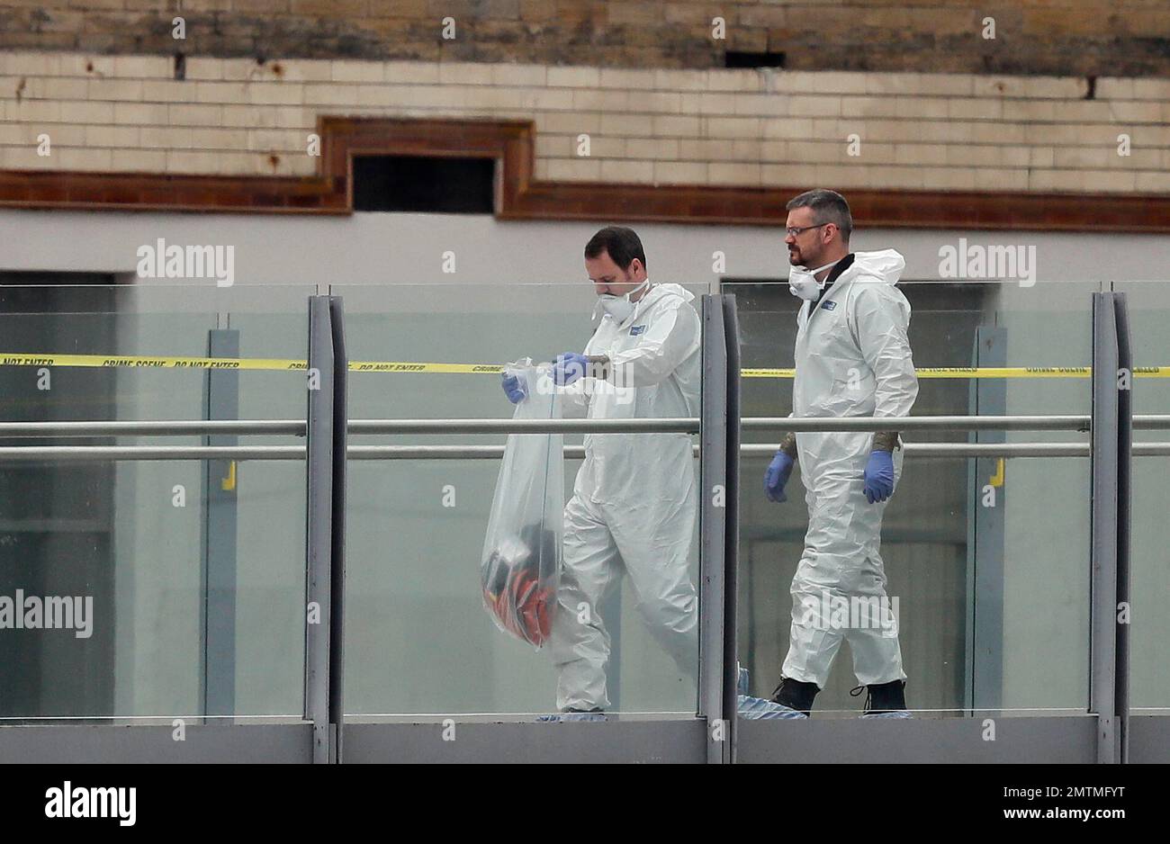 Forensic officers work near the Manchester Arena in Manchester ...