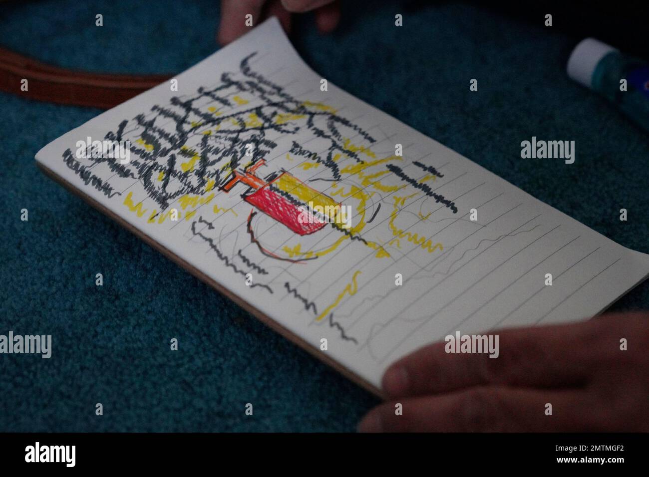 Talia Goss, a retreat participant, shows a drawing of a vision she had ...