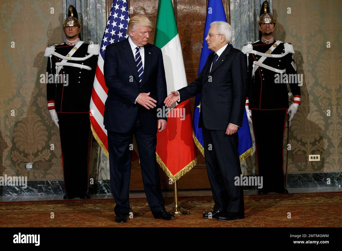 President Donald Trump walks with Italian President Sergio Mattarella ...