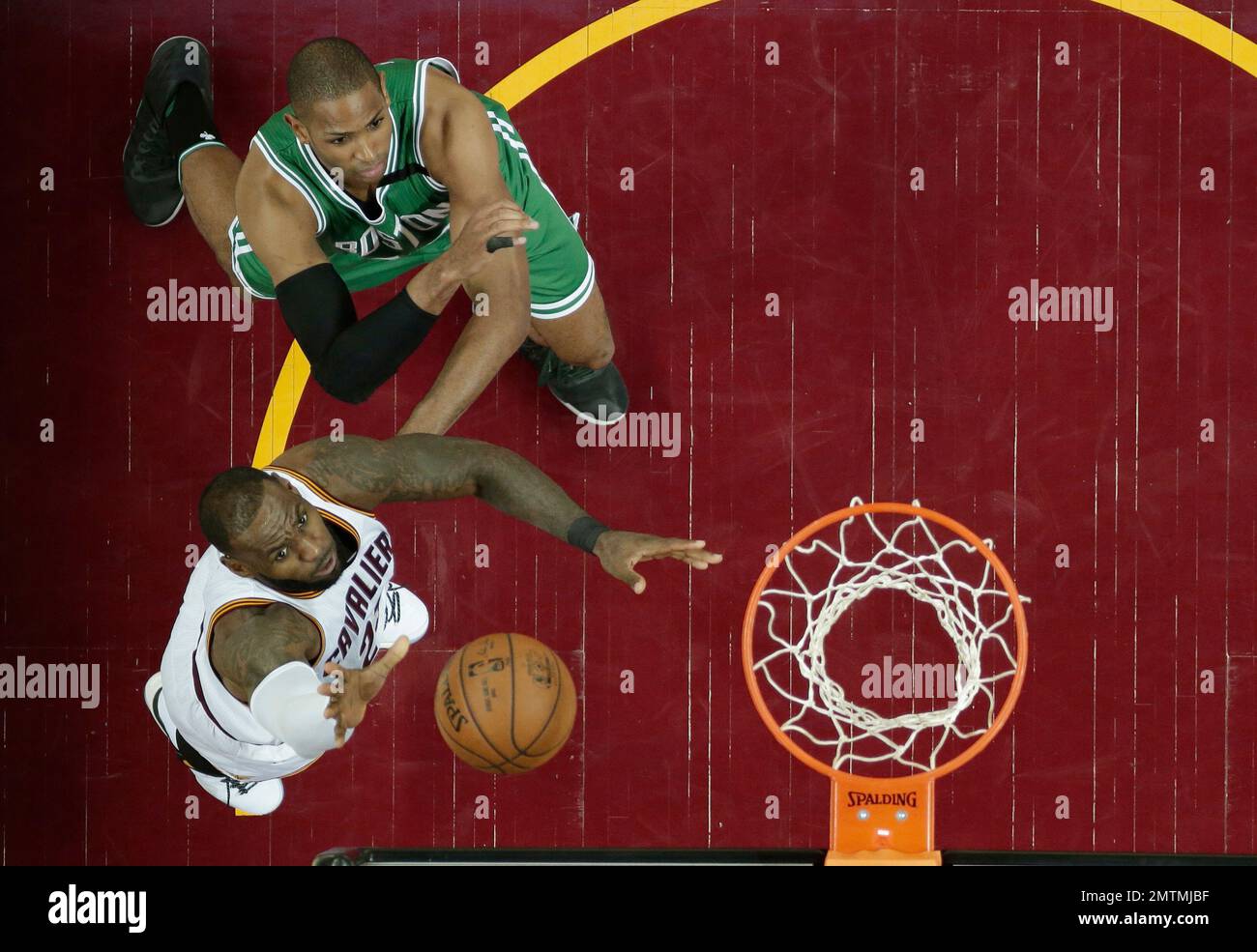 Cleveland Cavaliers' LeBron James, left, drives to the basket against ...