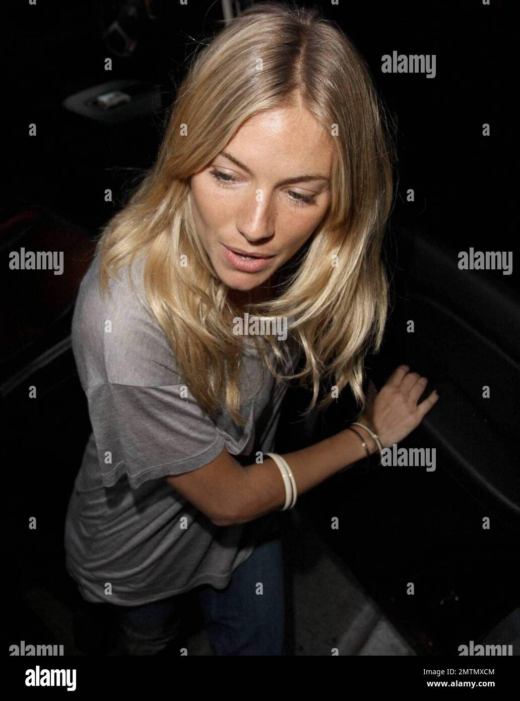 Actress Sienna Miller makes her way through a crowd of fans and ...
