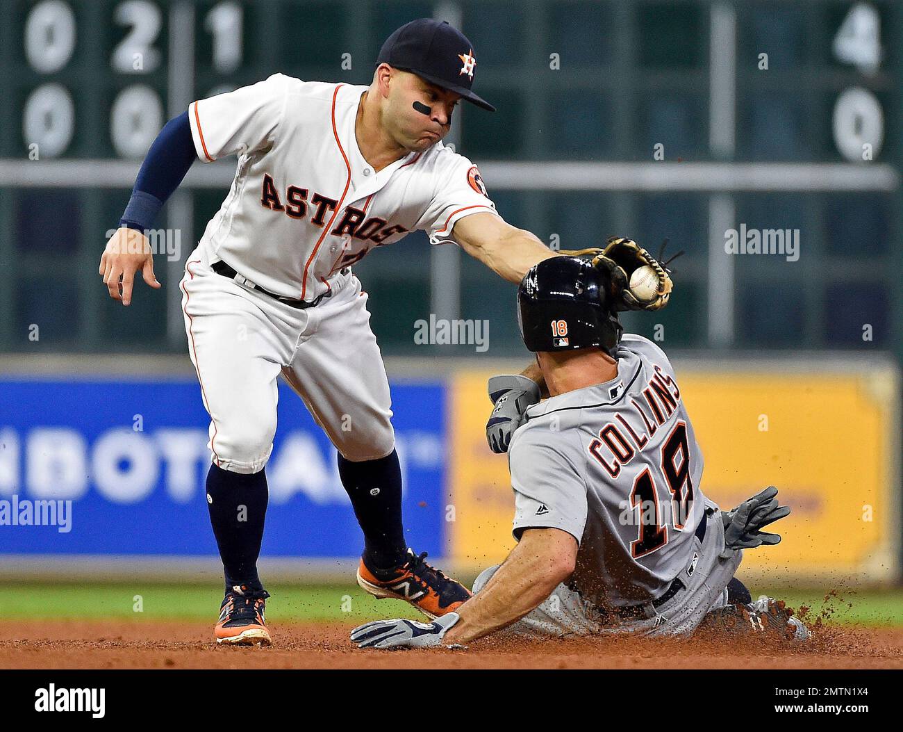 Detroit Tigers' Tyler Collins, right, is tagged out by Houston Astros ...