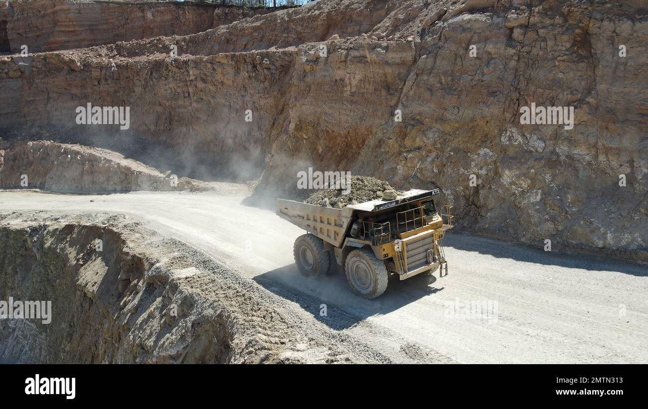 Large quarry dump truck full of stones. Transporting the ore into the ...