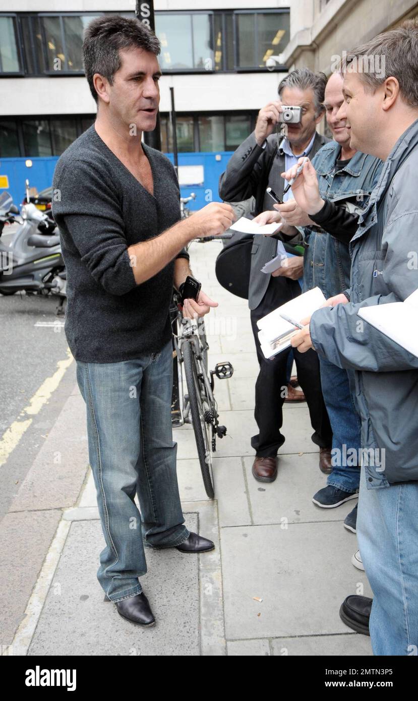 Former "American Idol" judge Simon Cowell arrives in a chauffeur-driven ...