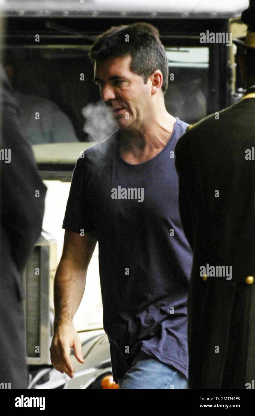 Exclusive!! Simon Cowell exchanges chit chat with a bellman as he steps ...
