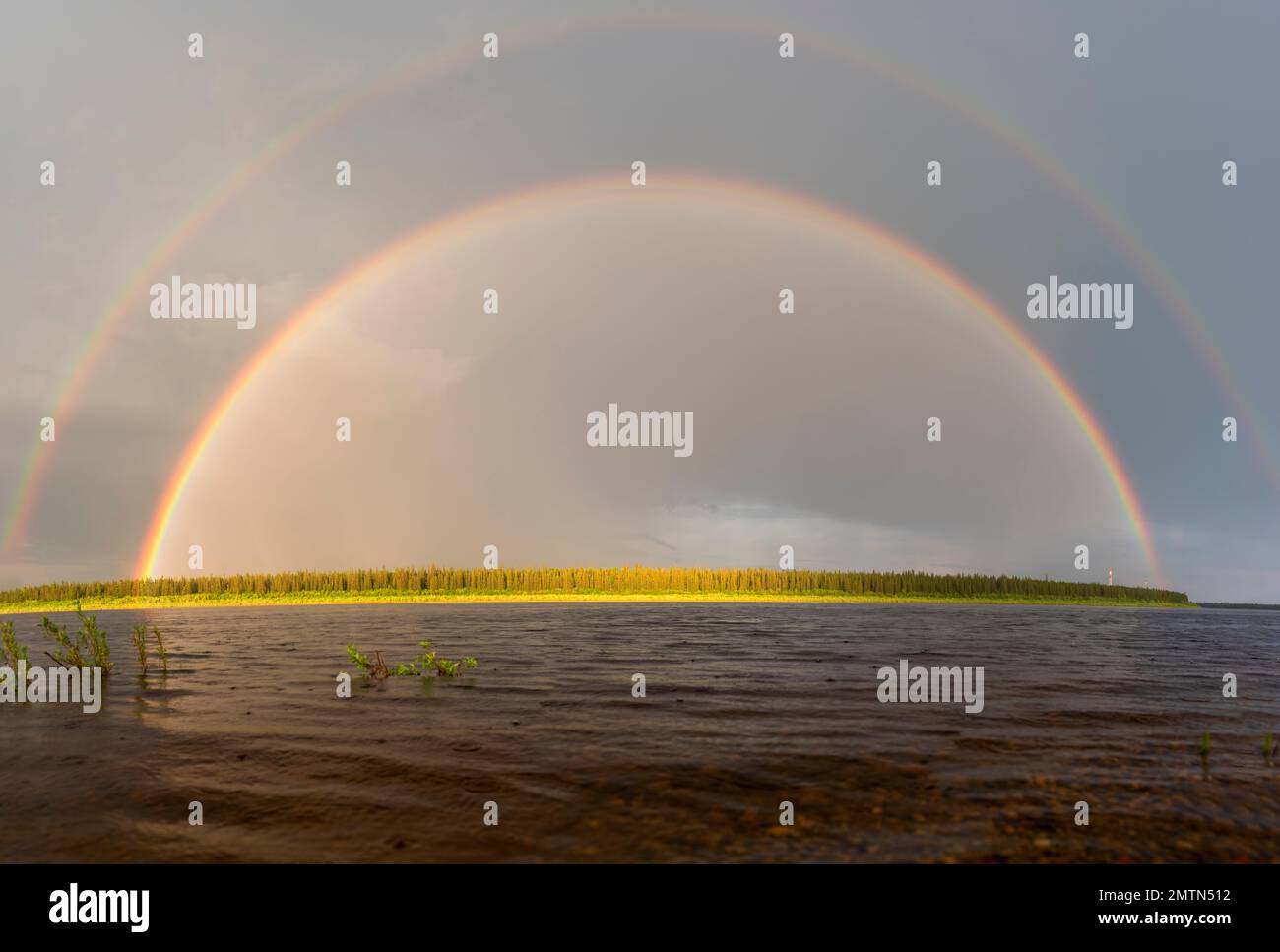 Panorama of a bright double rainbow over the Vilyui River after rain ...