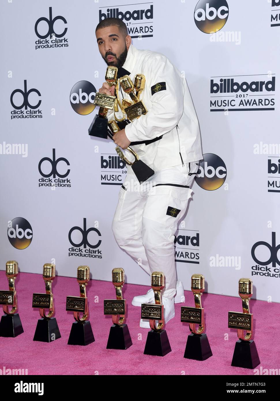 Drake poses in the press room with his 13 awards at the Billboard Music ...
