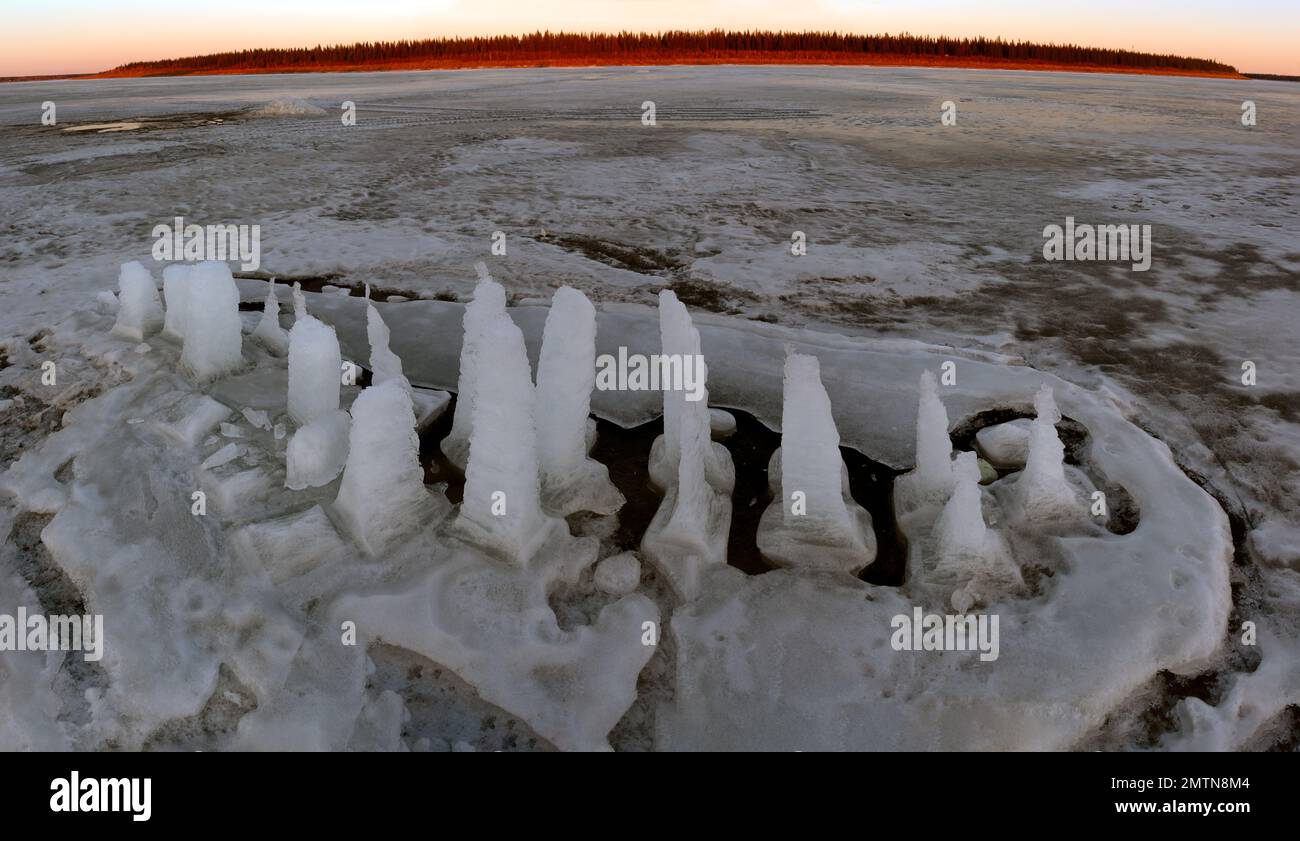 A panorama of abandoned and melting cut ice with pillars for defrosting ...