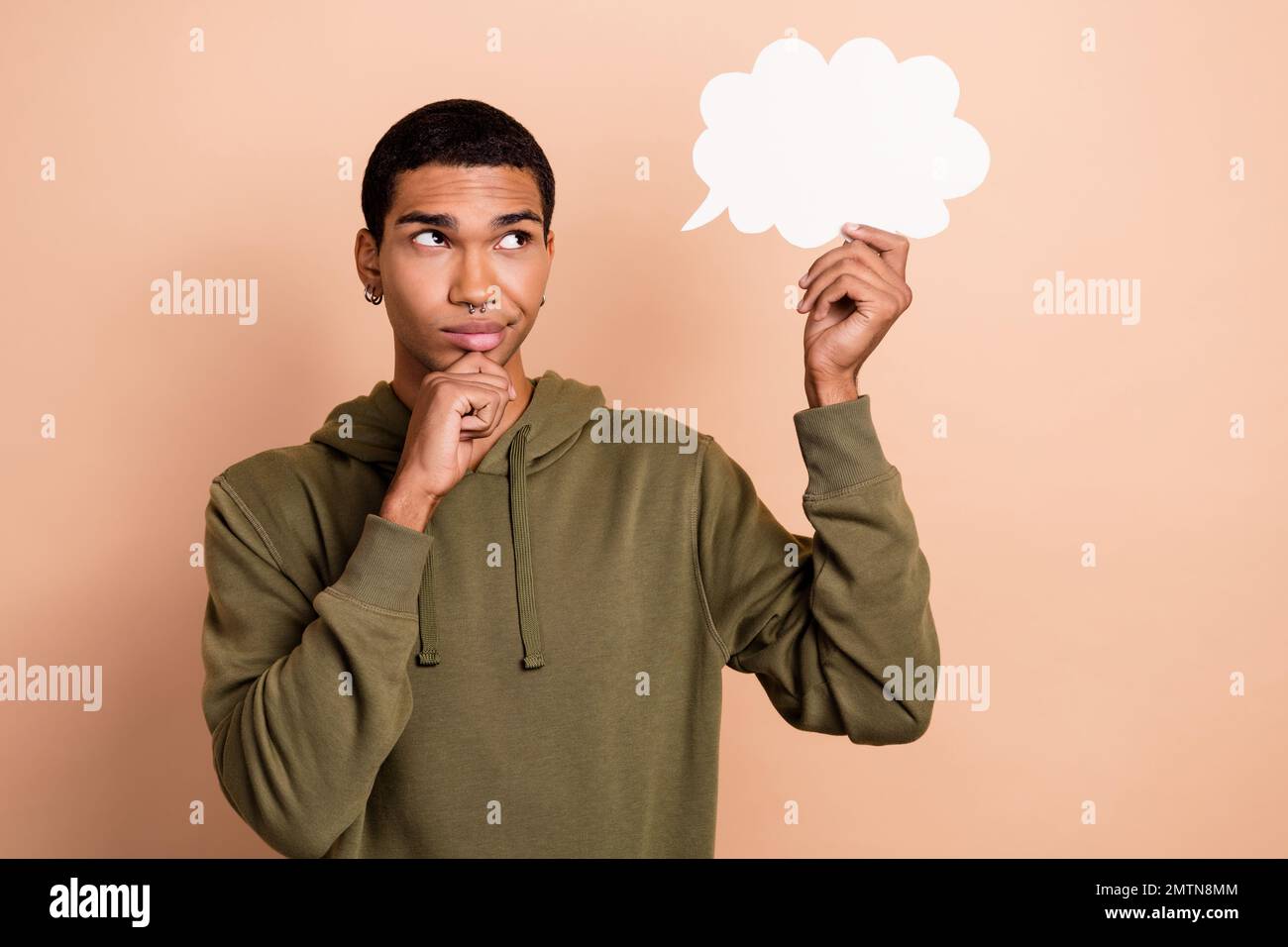 Photo of young minded smart man wear khaki sweatshirt touch chin think ...