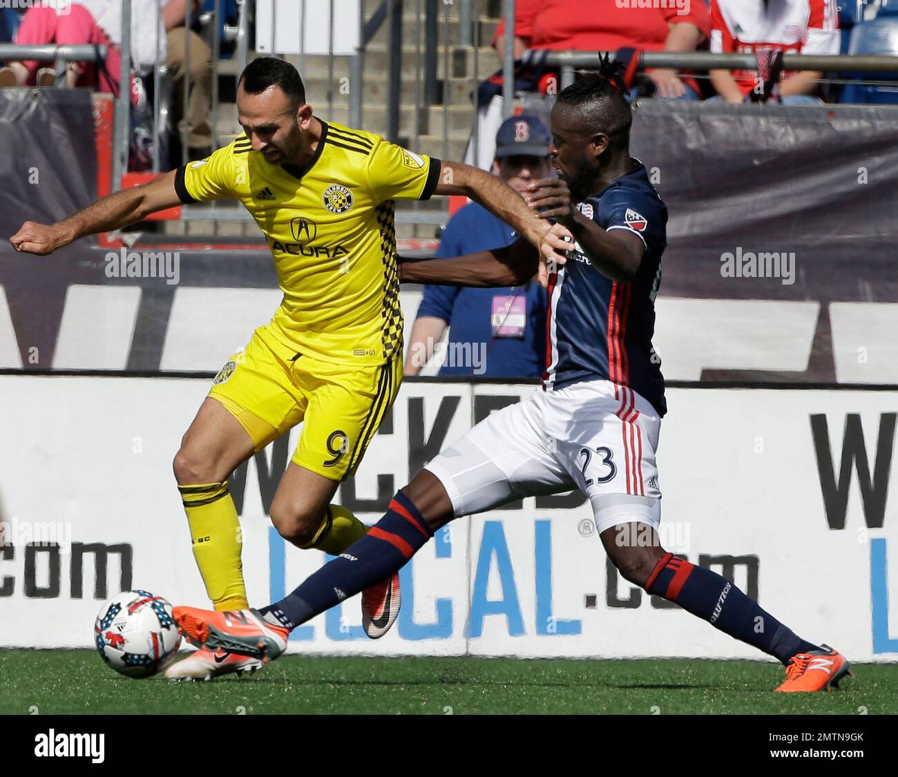 Columbus Crew forward Justin Meram (9) and New England Revolution ...