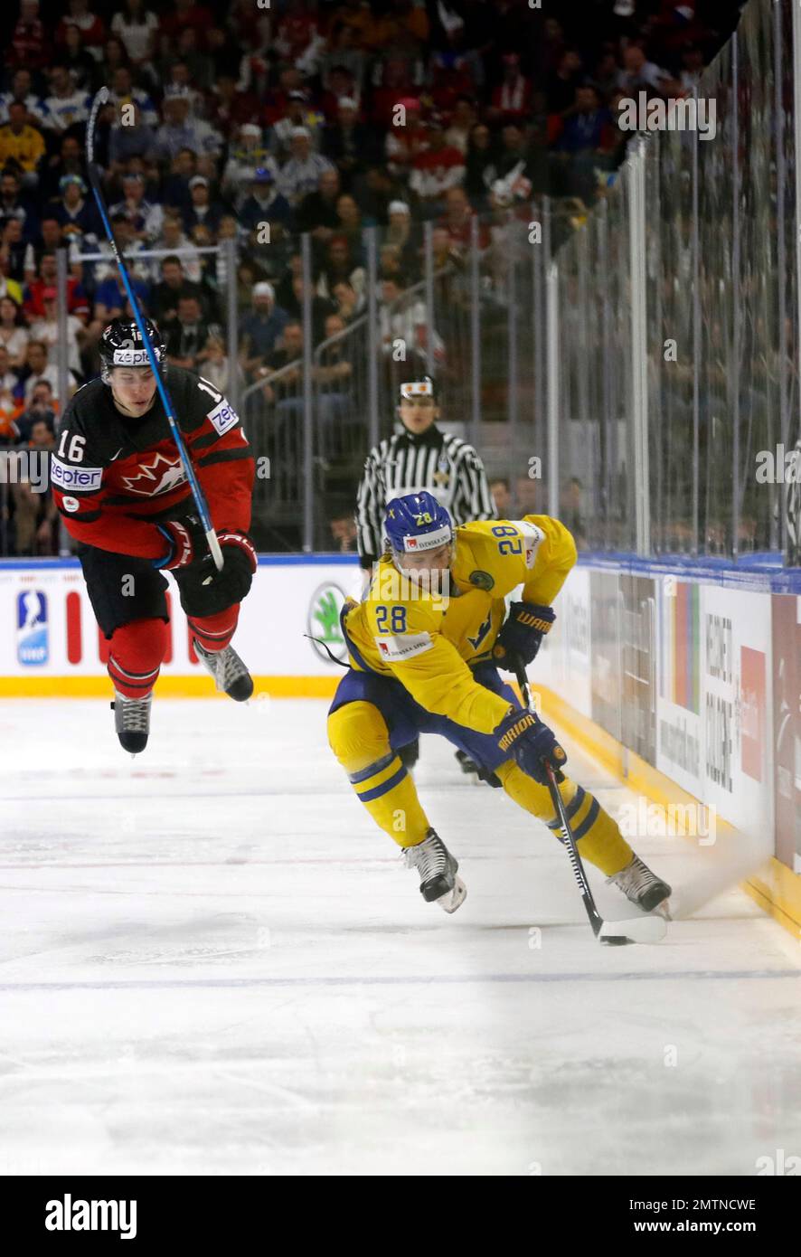 Sweden's Elias Lindholm, right, challenges for the puck with Canada's ...