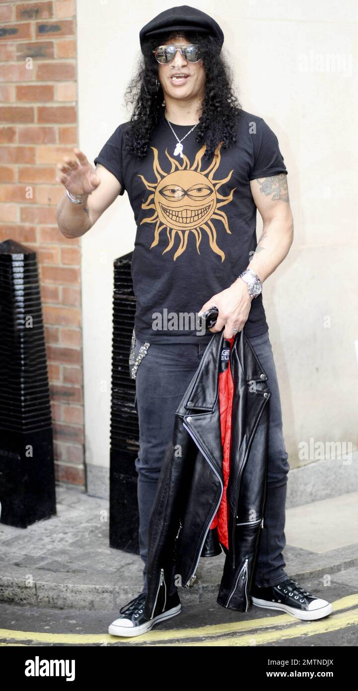 Rock guitarist Slash (Saul Hudson), sans his trademark top hat, looks ...