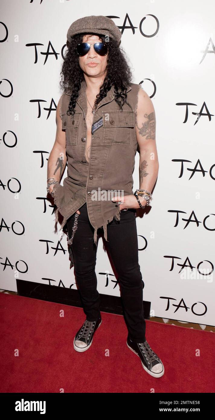 Legendary musician Slash (aka Saul Hudson) shows off his tattoos in a ...