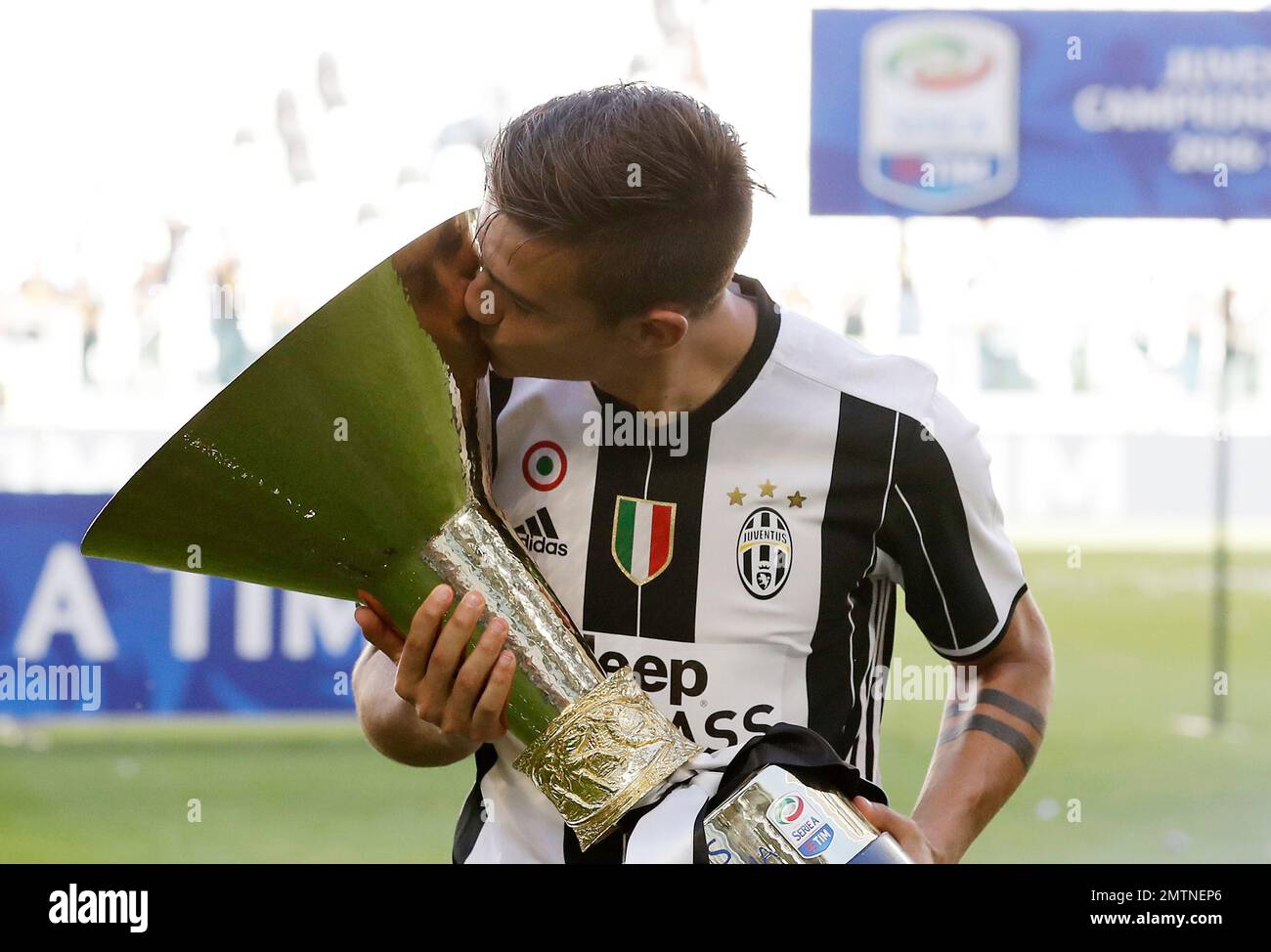 Juventus' Paulo Dybala kisses the trophy as Juventus players celebrate ...