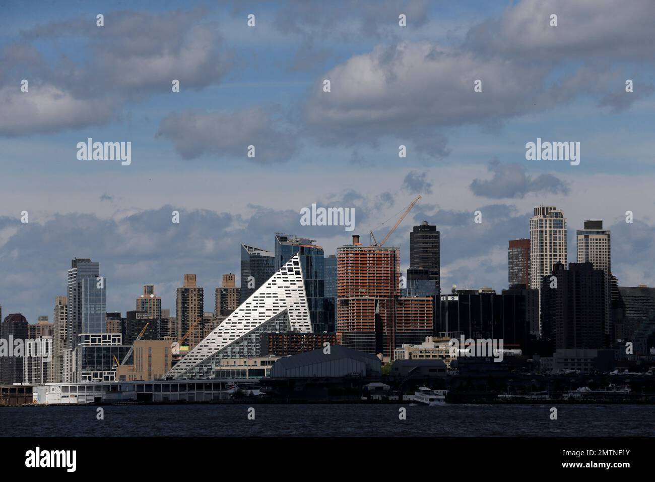Light reflects off a pyramid-shaped building on the west side of ...
