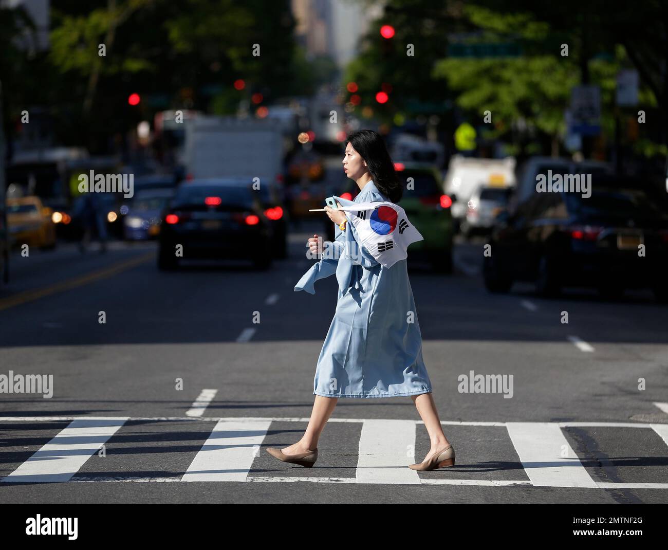 A student carrying a Korean flag arrives for a graduation ceremony at ...