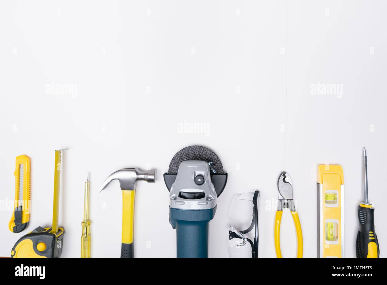 Top view selective focus grinder and construction DIY tools on white ...