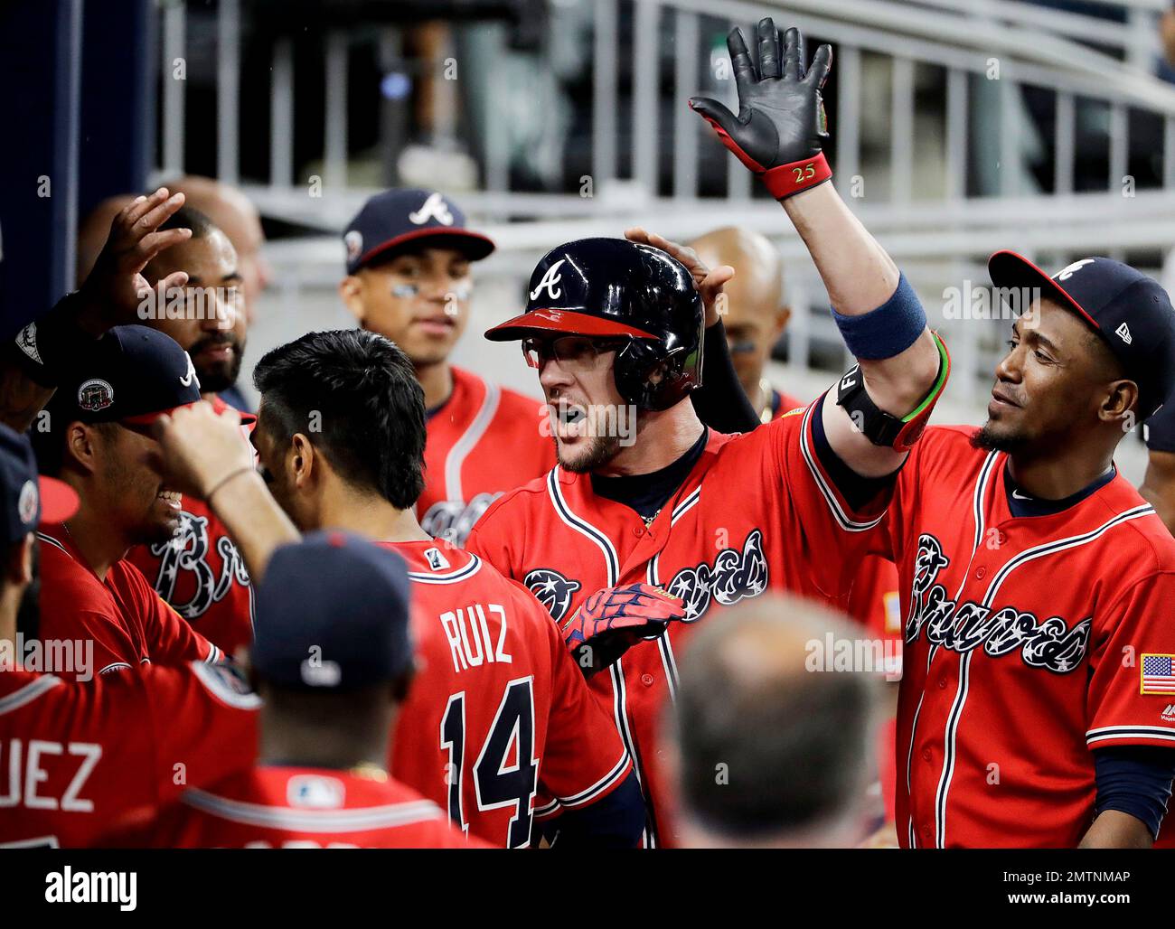 Atlanta Braves' Tyler Flowers, center, high-fives teammates after ...