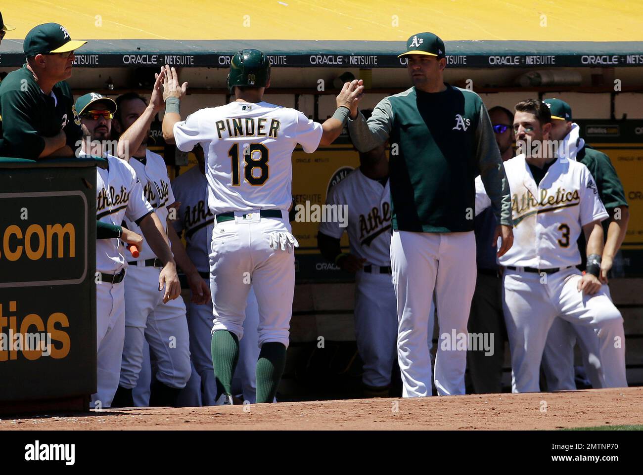 Oakland Athletics' Chad Pinder (18) is congratulated after scoring ...