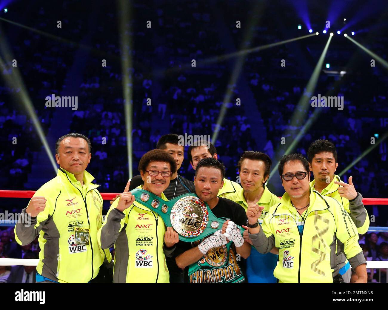 Japan's Daigo Higa, center, poses with his WBC flyweight boxing champion belt and his gym's ...