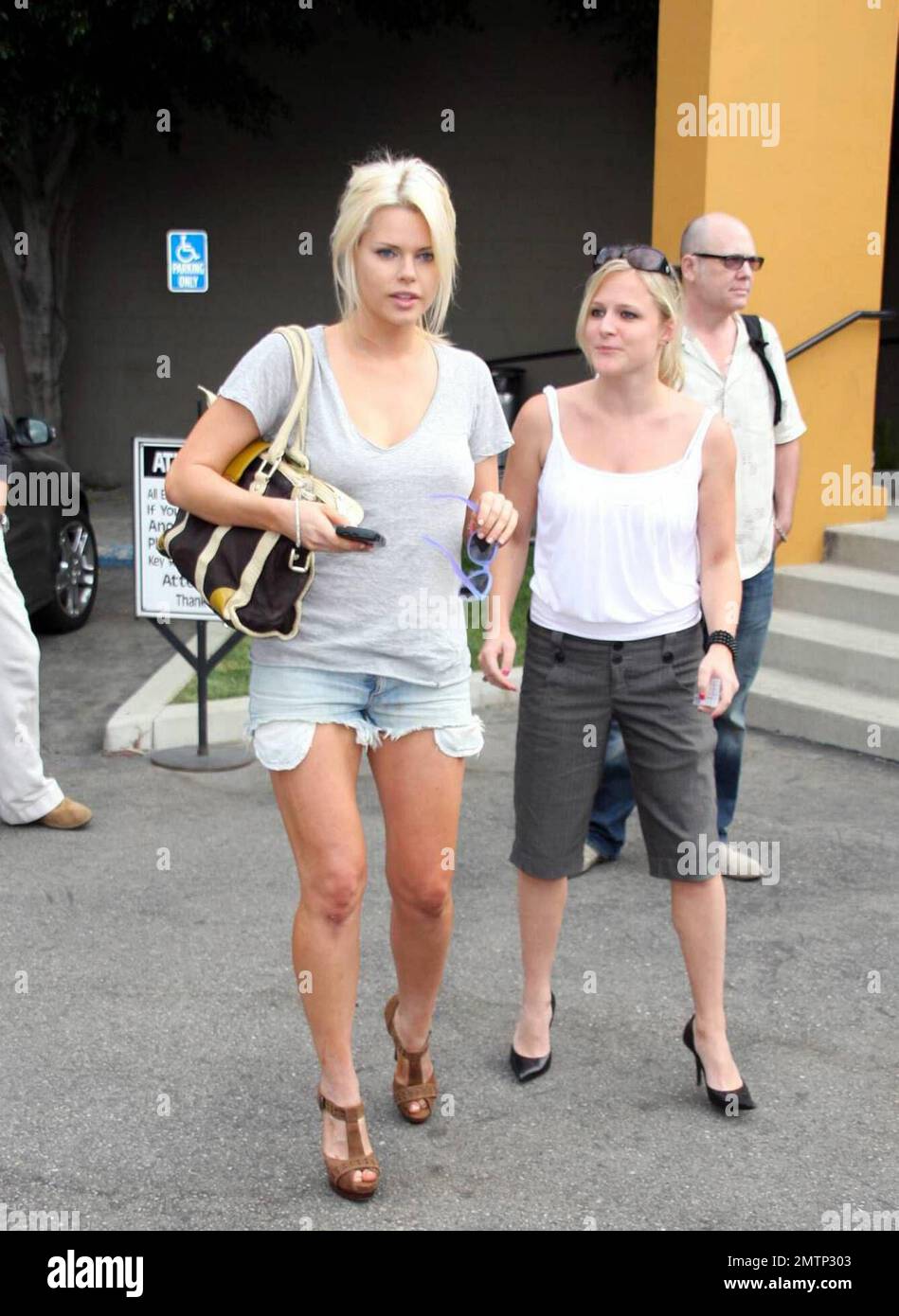 Sophie Monk wears some "Daisy Dukes" short shorts while she waits for ...