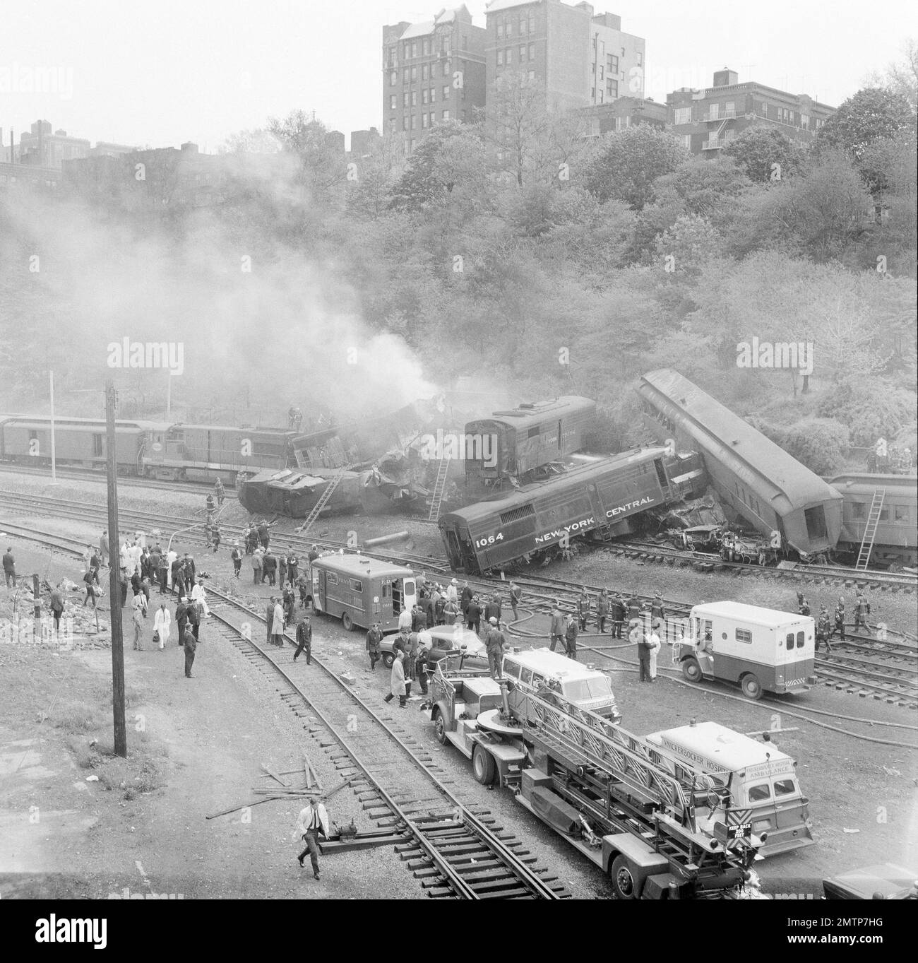Firemen look at a tangled wreckage after two trains collided head-on in ...